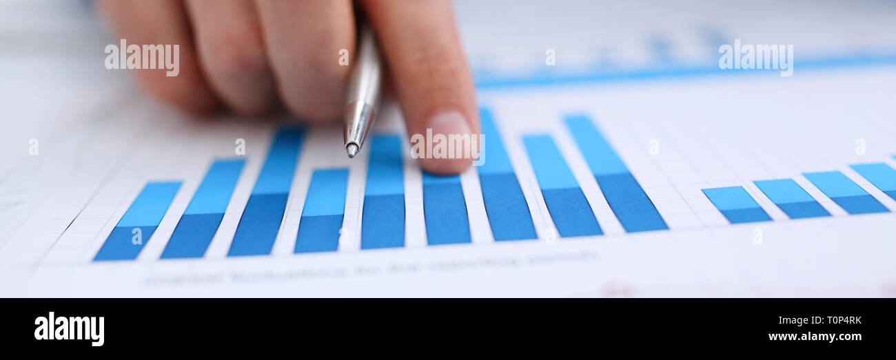 Male hands hold documents with financial statistics Stock Photo - Alamy