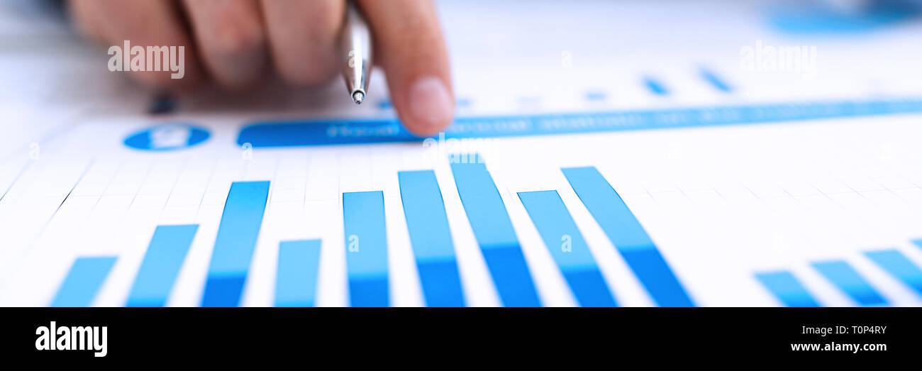 Male hands hold documents with financial statistics Stock Photo - Alamy