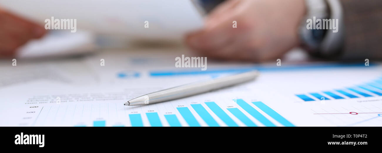 Group of people deliberate on problem with infographics closeup Stock ...