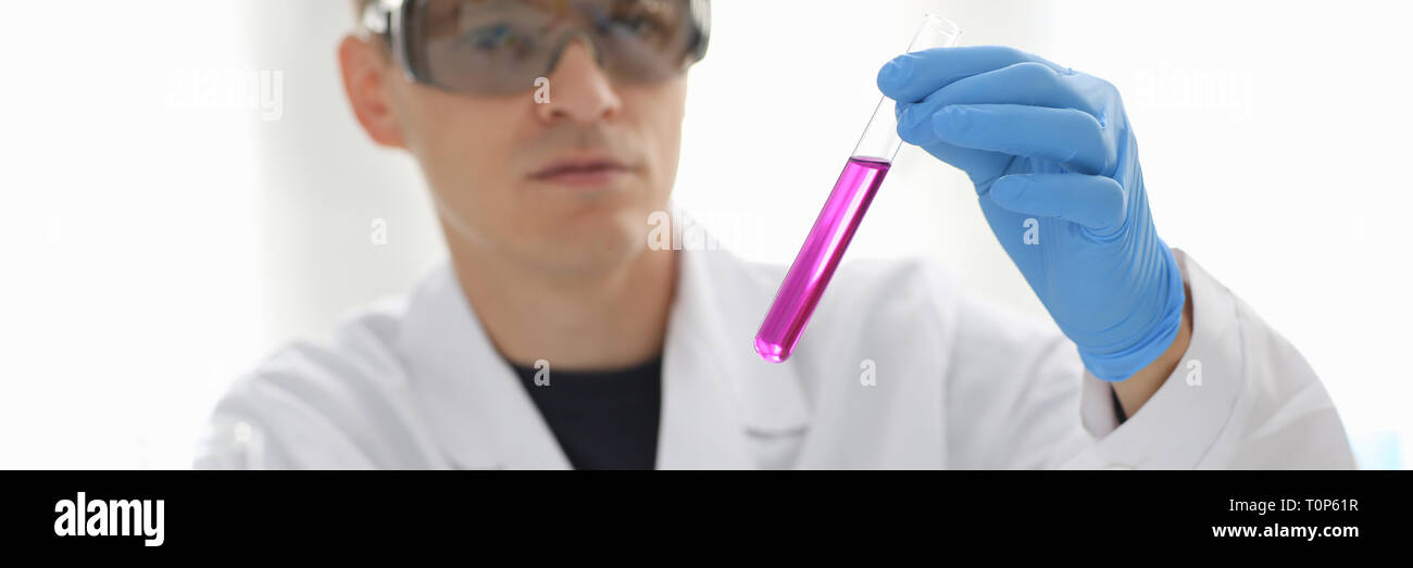 A male chemist holds test tube of glass Stock Photo - Alamy