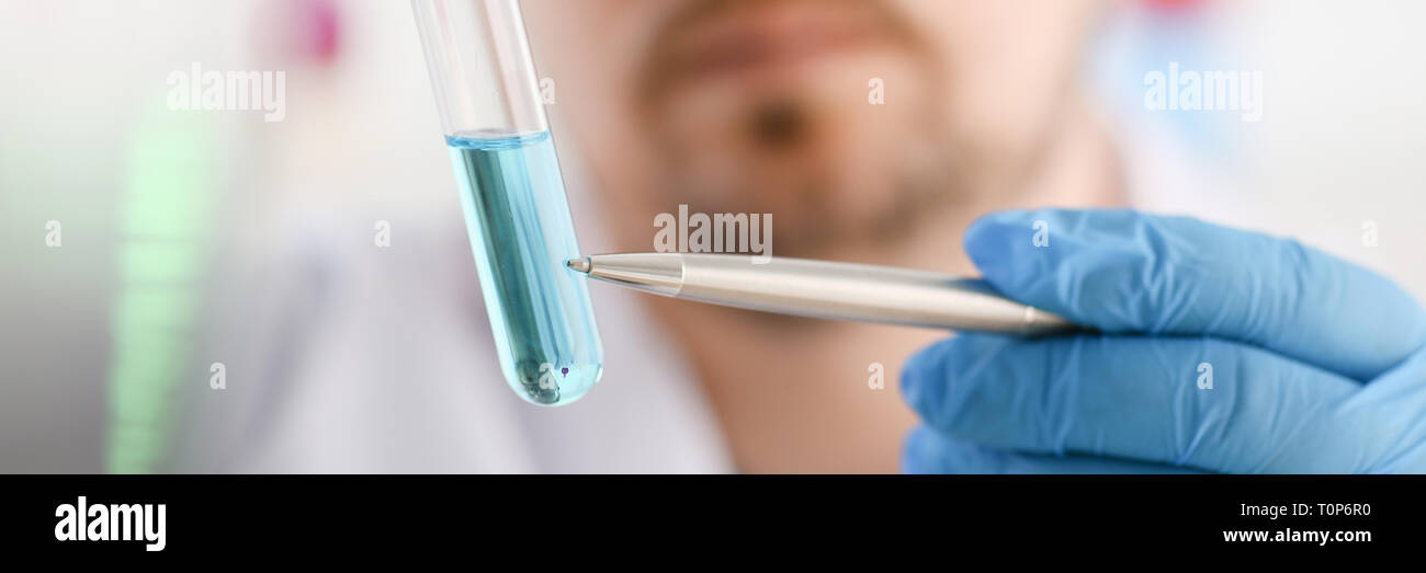 A male chemist holds test tube of glass Stock Photo - Alamy