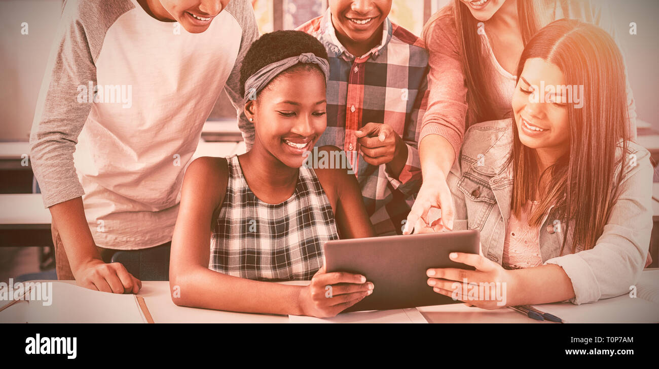 Group of students using digital tablet in classroom Stock Photo - Alamy