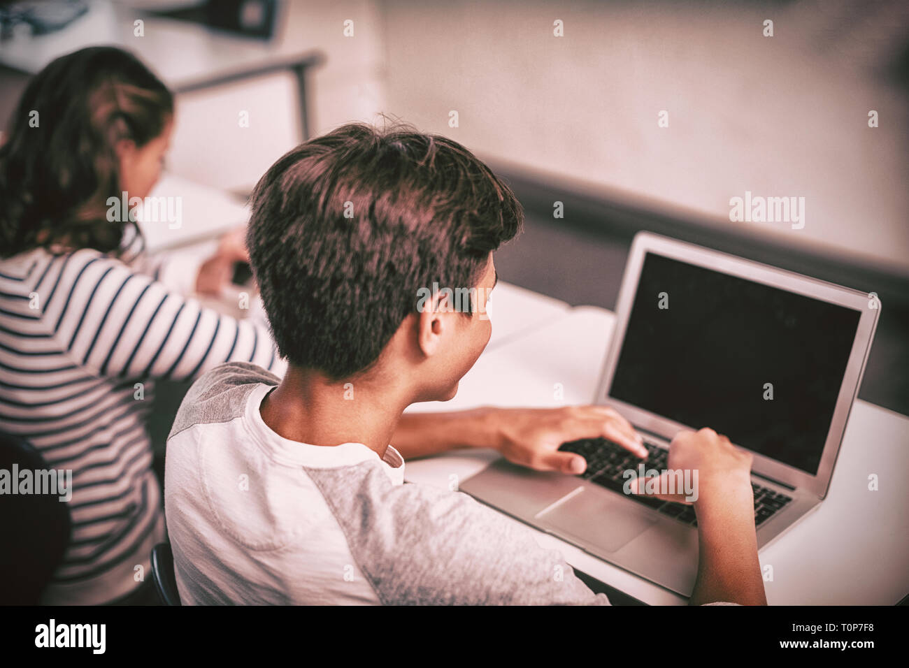 Student using laptop in classroom Stock Photo - Alamy