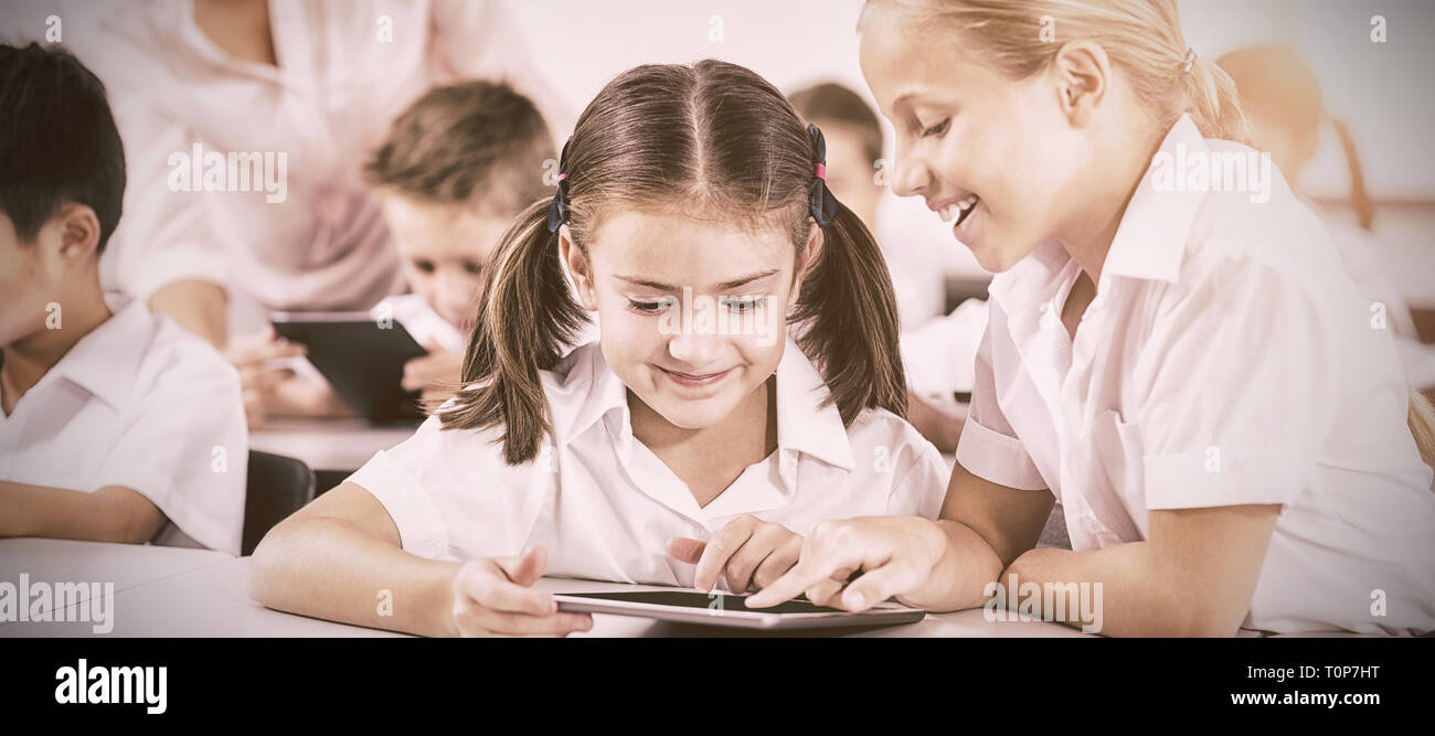 Children using digital tablets in classroom Stock Photo - Alamy