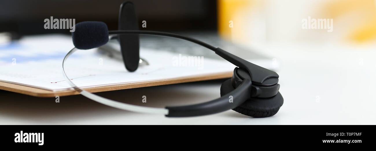 Empty remote office workplace with laptop and headset Stock Photo - Alamy