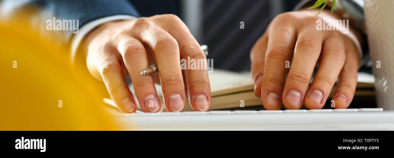 Male arms in suit typing on silver keyboard Stock Photo - Alamy