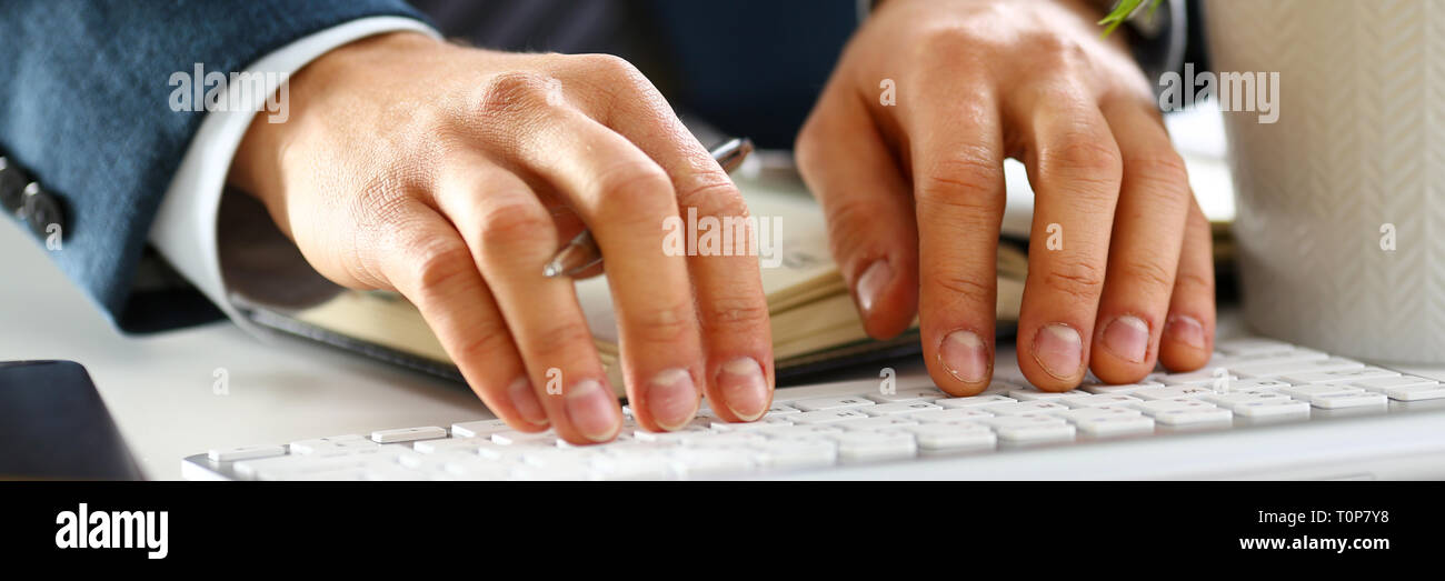 Male arms in suit typing on silver keyboard Stock Photo - Alamy