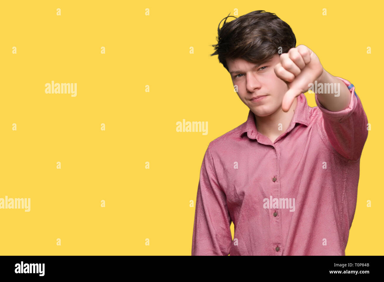 Young handsome business man over isolated background looking unhappy ...