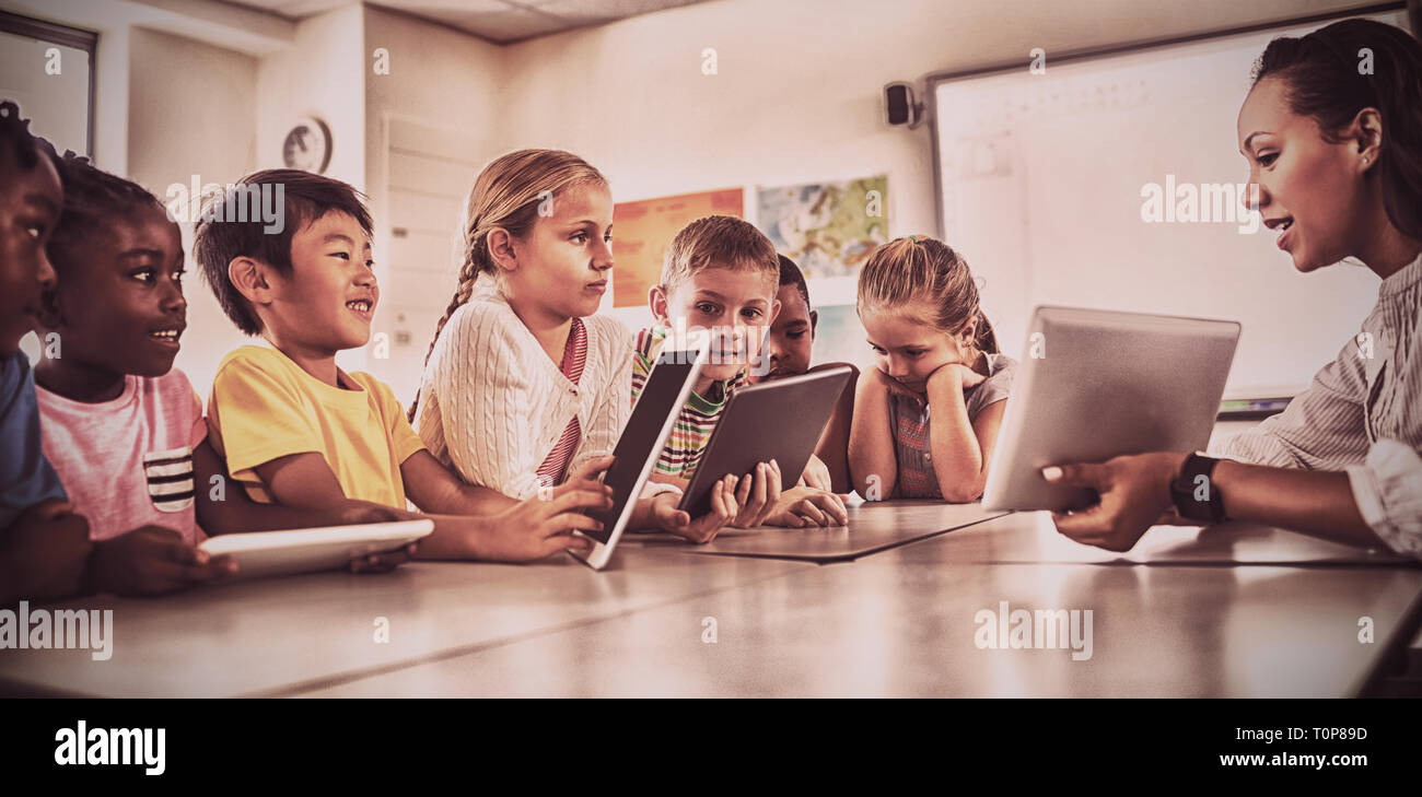 Teacher having lesson with tablet pc Stock Photo - Alamy