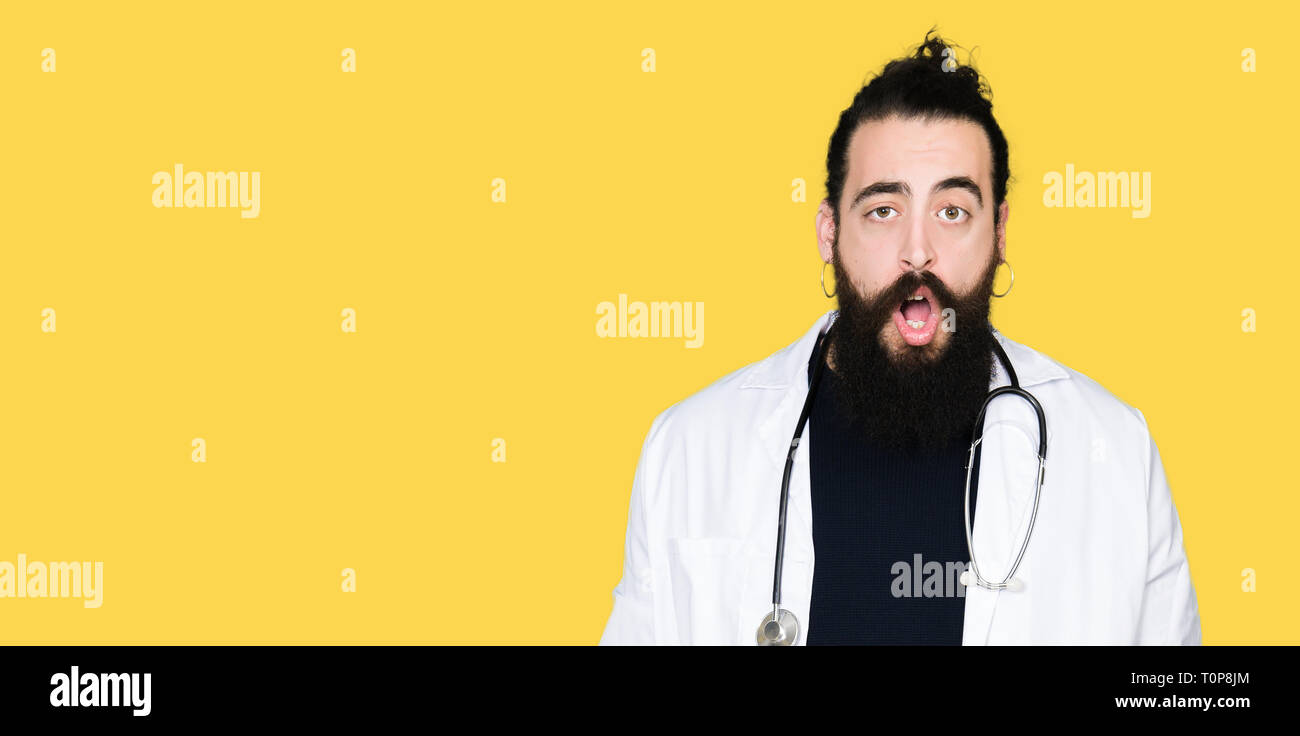 Doctor with long hair wearing medical coat and stethoscope In shock ...