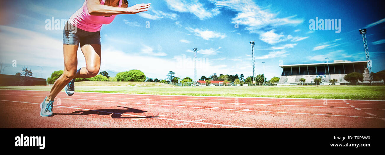 Female athlete running on running track Stock Photo - Alamy