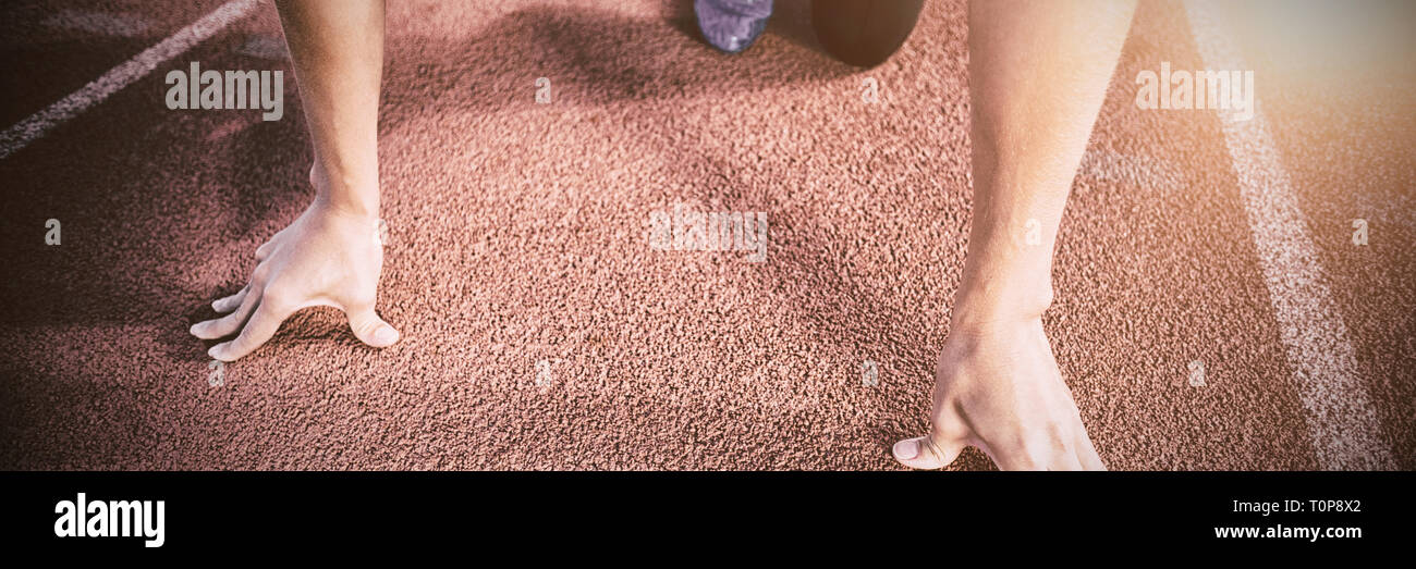 Female athlete in ready to run position Stock Photo - Alamy