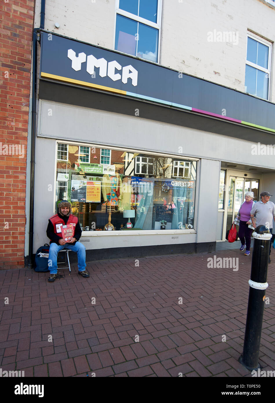 A Big Issue seller sat outside of the YMCA shop, East Yorkshire, March ...