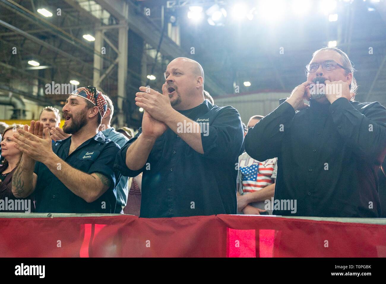 U.S President Donald Trump is cheered by employees during his address ...