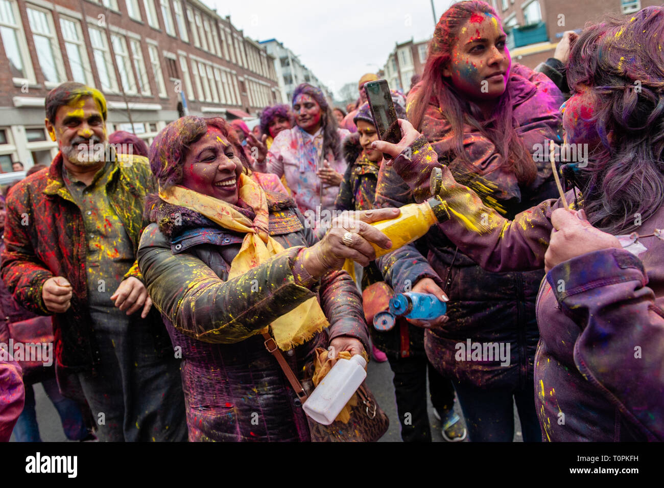 An Indian woman is seen throwing coloured powders while another person ...