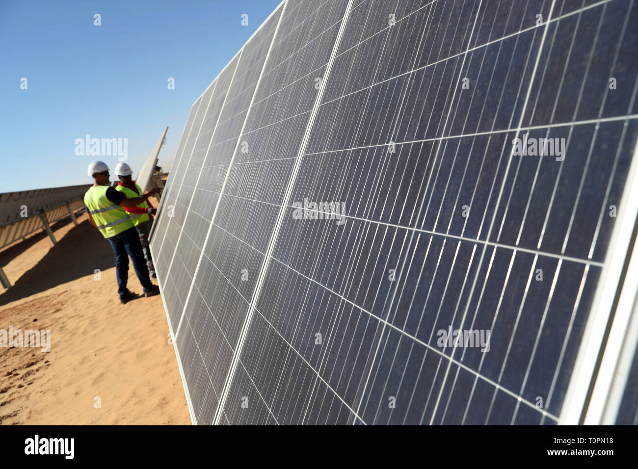 Aswan. 18th Mar, 2019. People work in a TBEA solar power station in ...