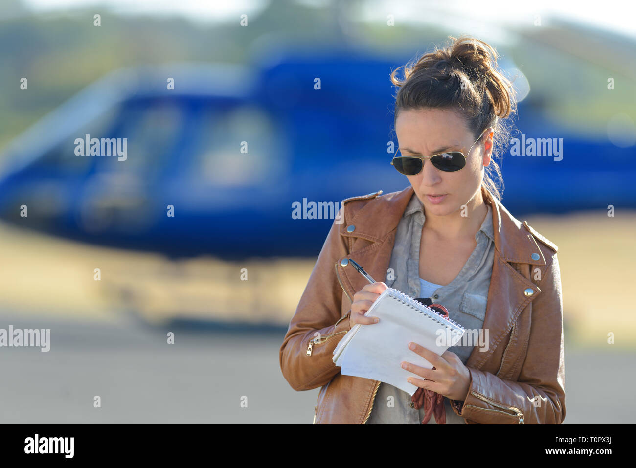 beautiful woman pilot with paperwork before flying Stock Photo - Alamy