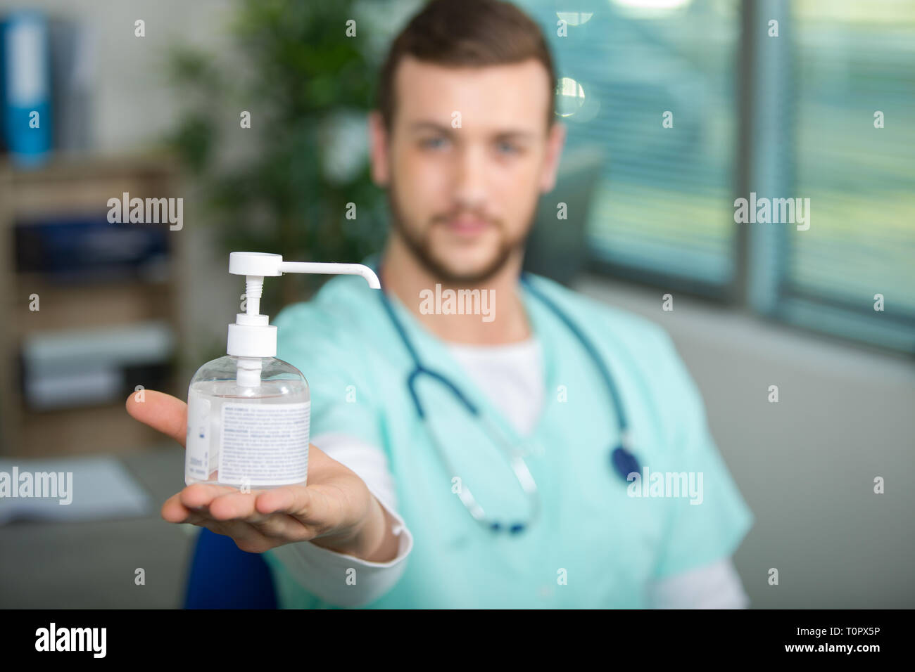 doctor sanitising hands Stock Photo - Alamy