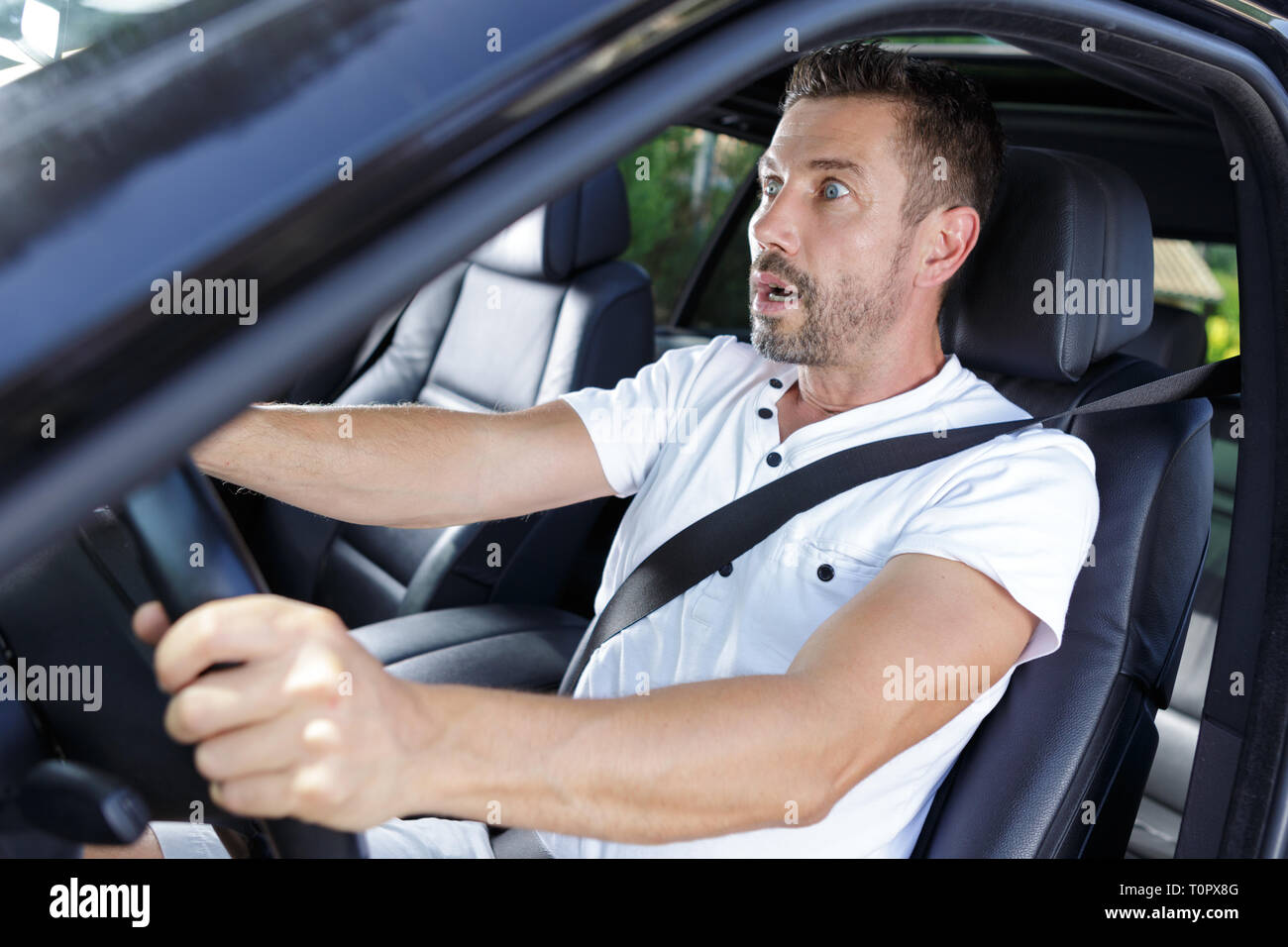 male car driver with shocked and fearful expression Stock Photo - Alamy