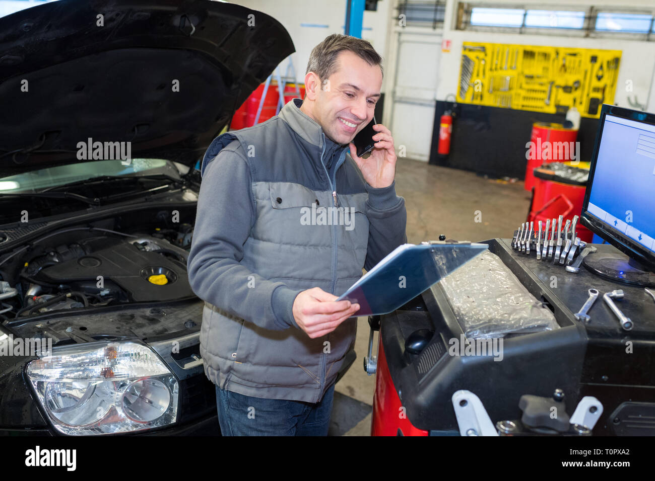 car mechanic using telephone Stock Photo - Alamy