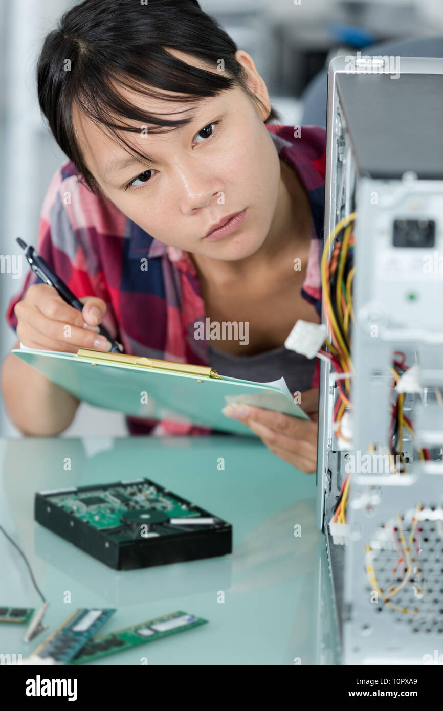 female technician fixing computer Stock Photo - Alamy