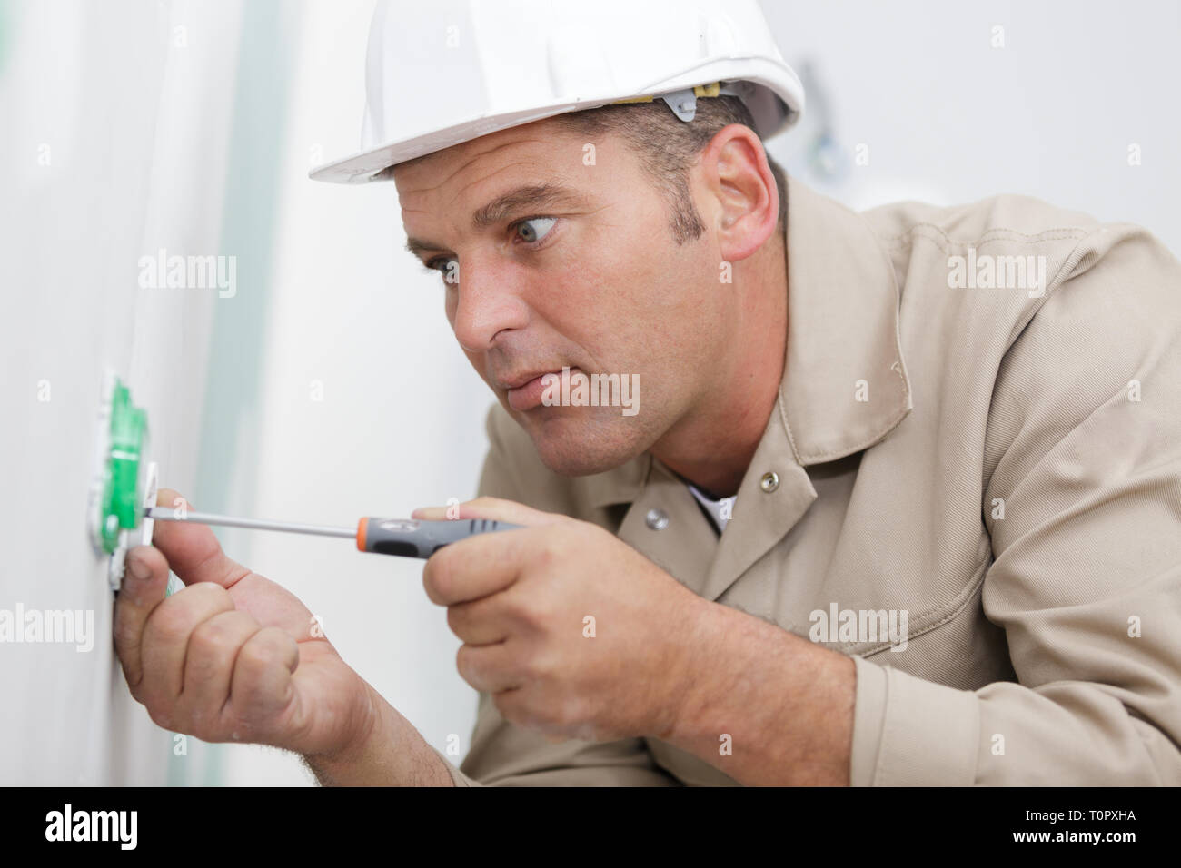 Electrician working on plug hi-res stock photography and images - Alamy