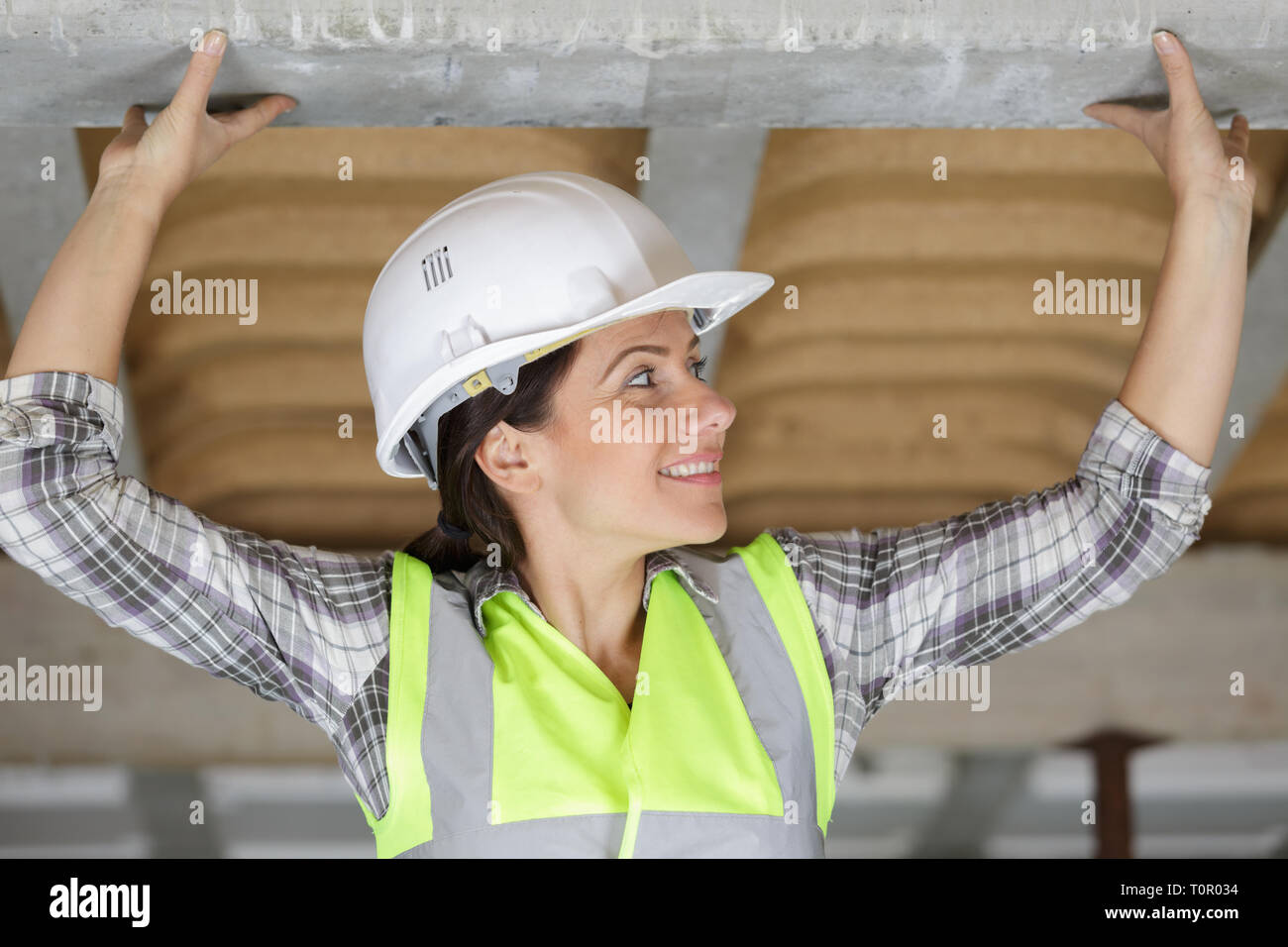 Female construction standing on roof hi-res stock photography and ...