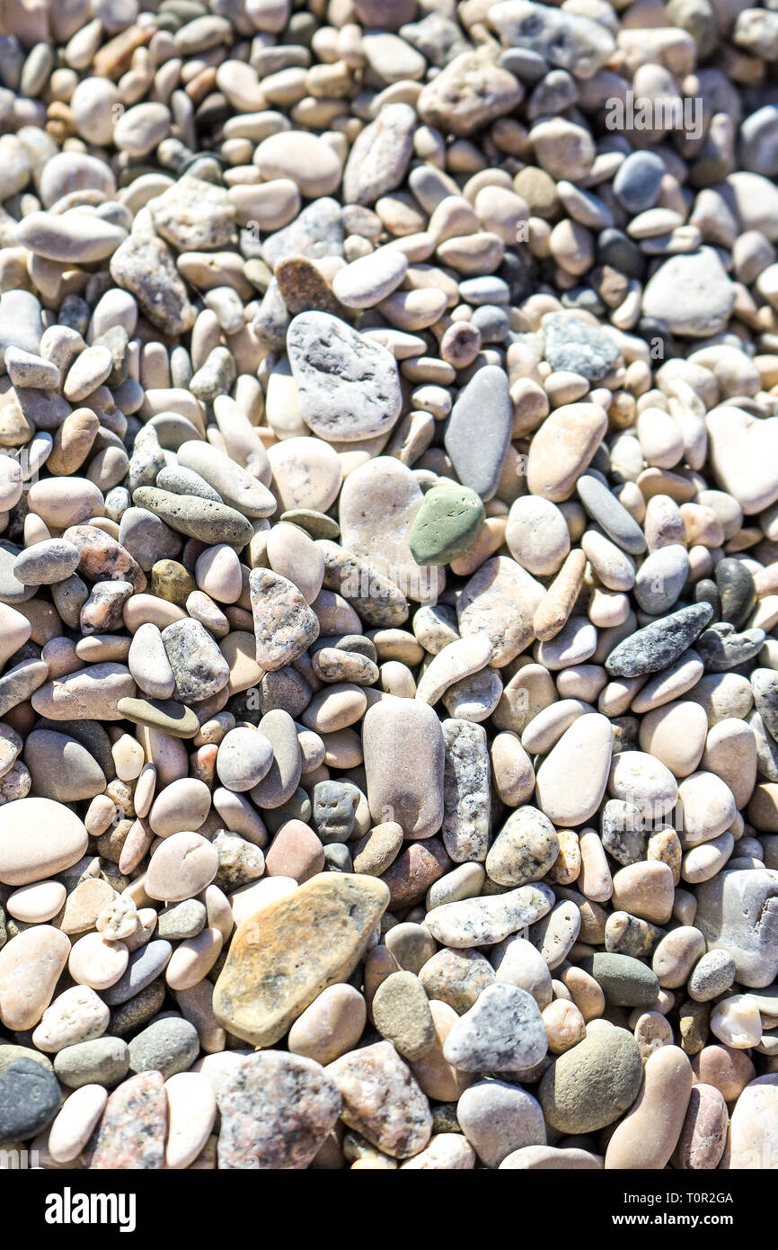 Pebble stones of different colors and shapes background Stock Photo - Alamy