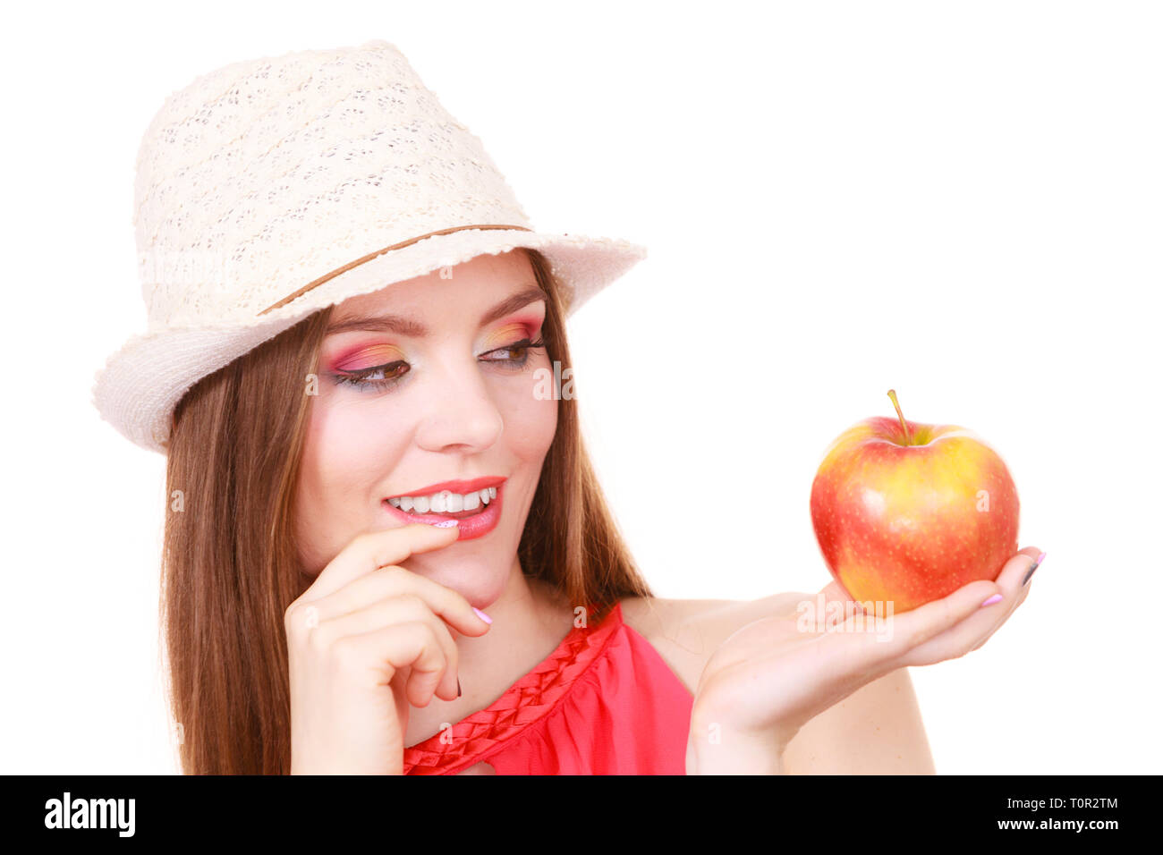 Woman charming girl long hair colorful make up wearing summer hat holds big red apple fruit ...