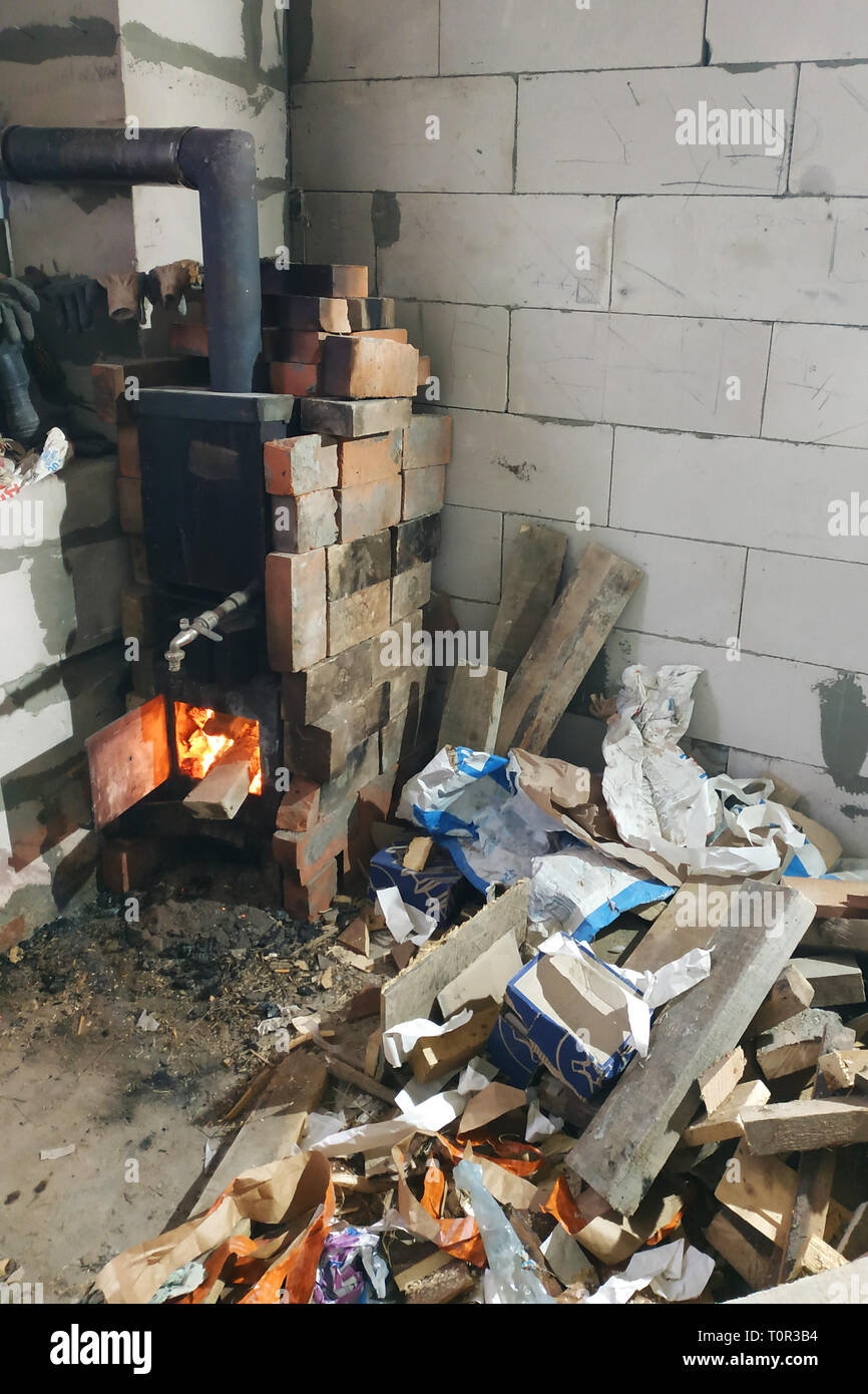 The wood-burning stove burns with open doors in violation of poses a ...