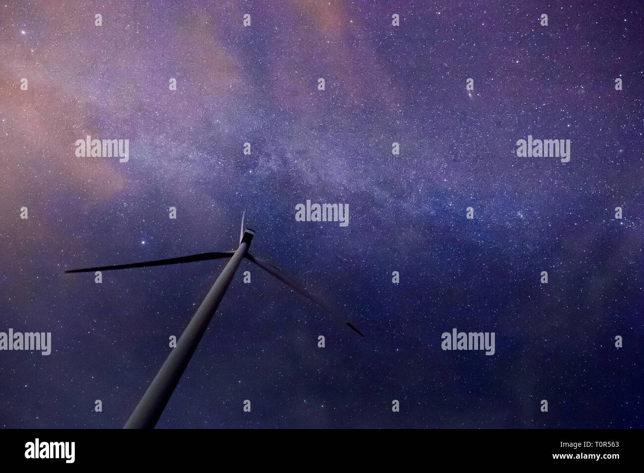 One wind turbine with beautiful milky way in background with bright ...