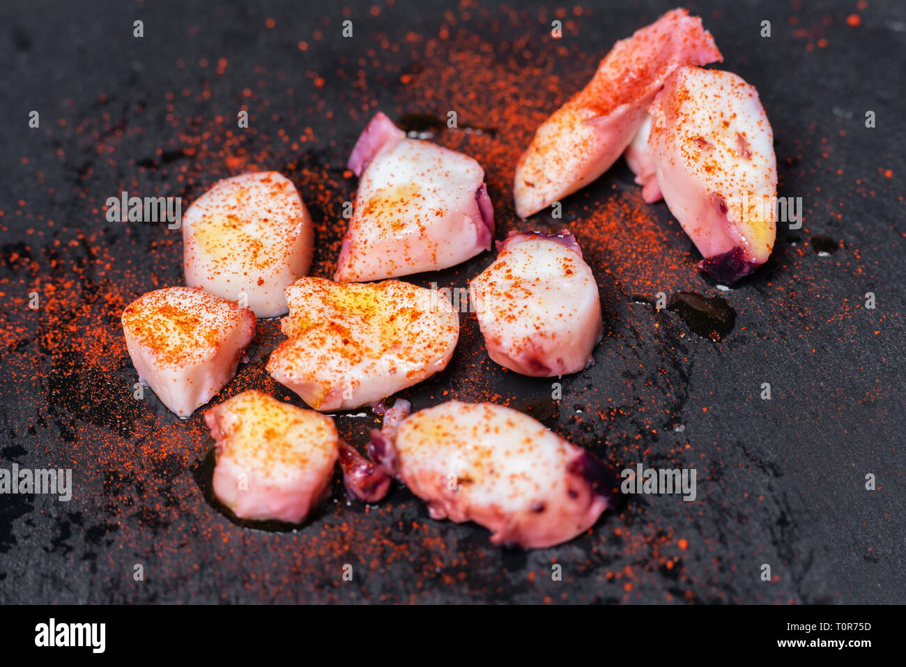 Delicious Galician octopus, pulpo a la gallega, on black slate Stock ...