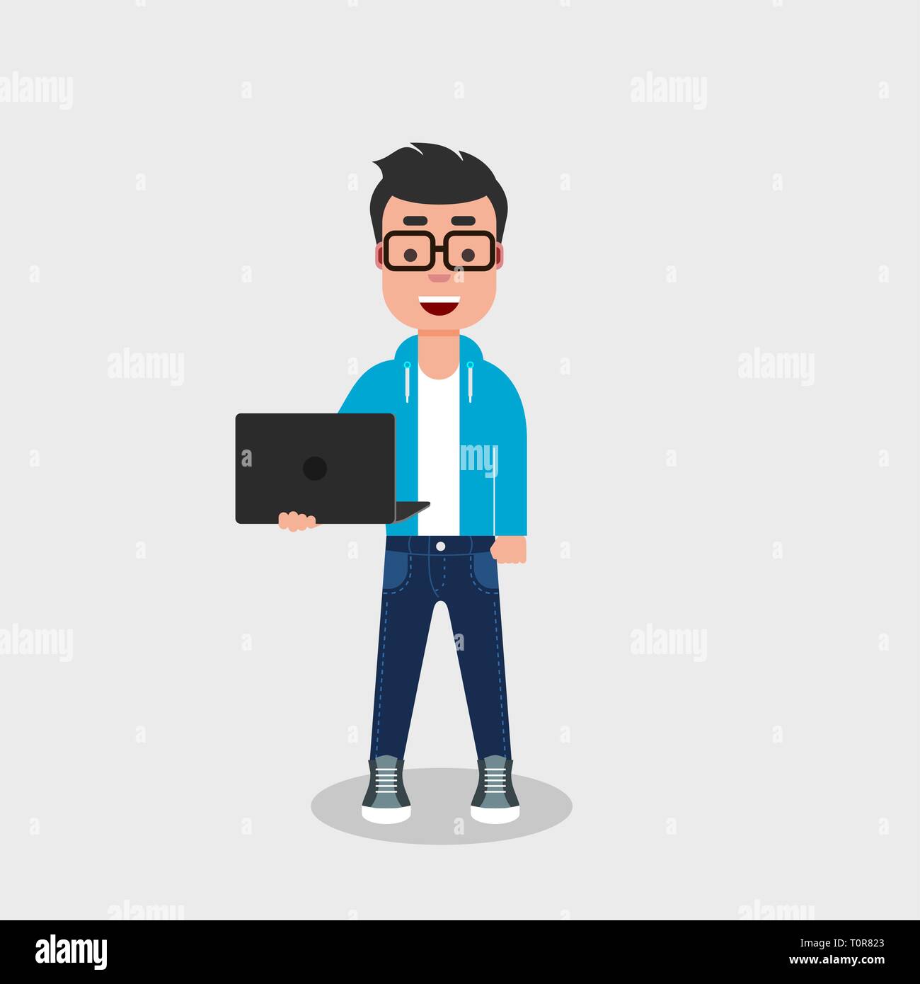 Young man holding laptop computer. Geek standing with laptop in hands ...