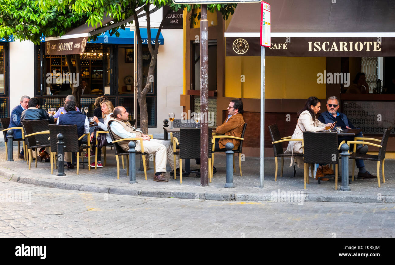 People having drinks at a sidewalk bar in Seville Stock Photo - Alamy