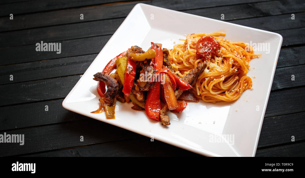 Homemade spaghetti pasta with beef meat and various vegetables on a ...