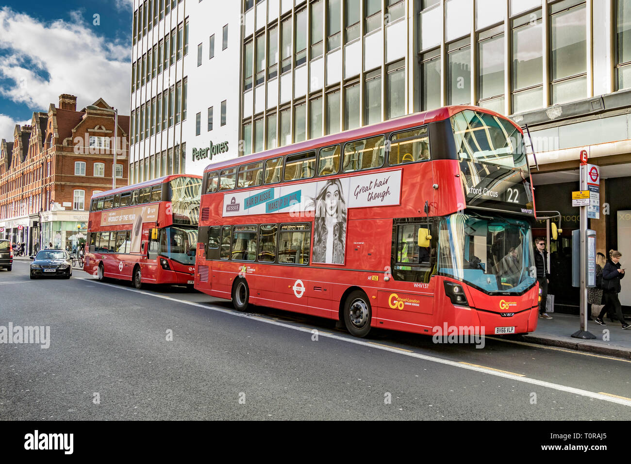 Two London double decker buses on The Kings Road at a bus stop outside ...