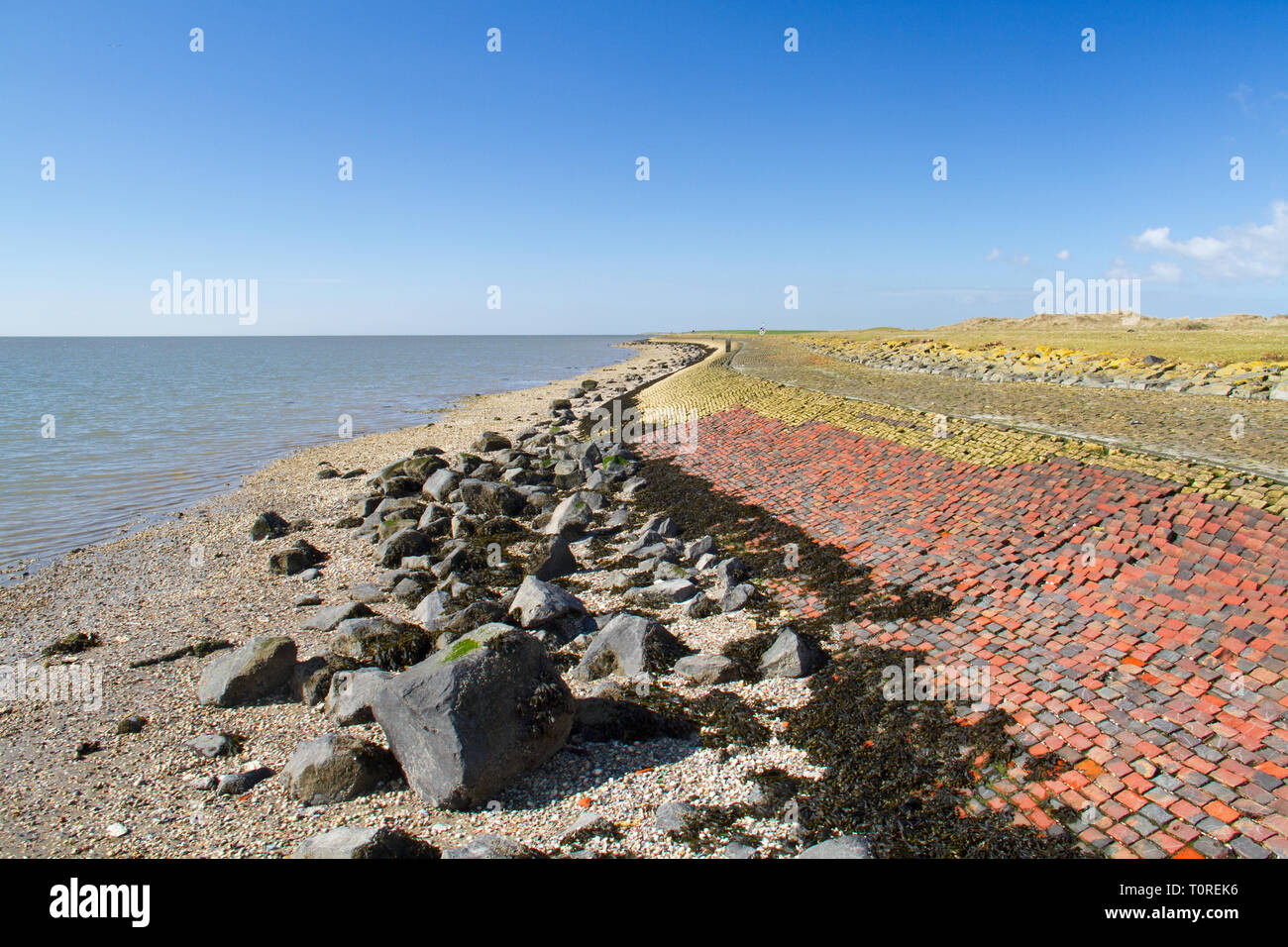 Solid dike in the Netherlands, boulders and bricks used for toe ...