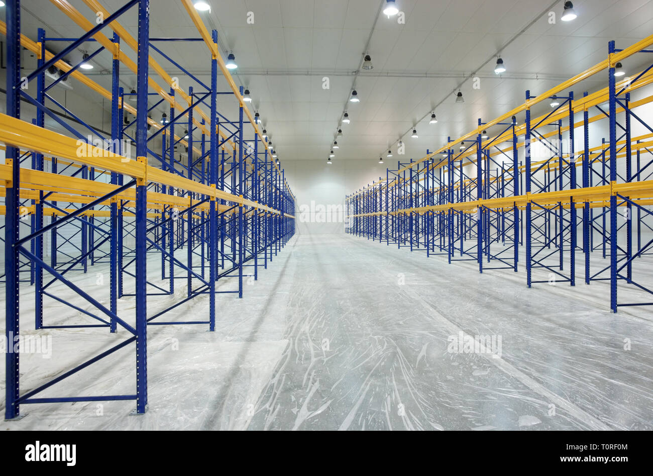 Large newly built warehouse with steel shelves Stock Photo - Alamy