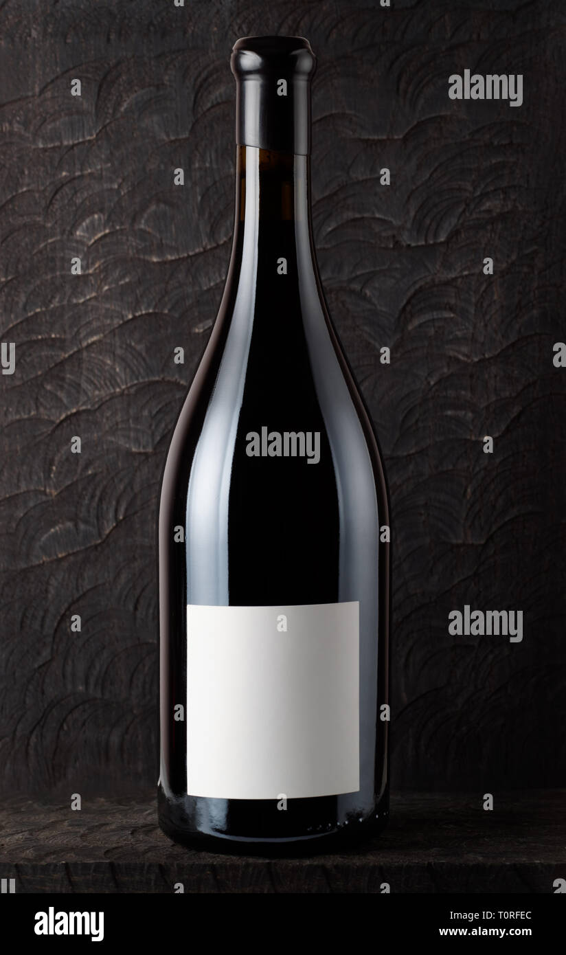 Bottle of Shiraz red wine, old wooden surface in background Stock Photo ...