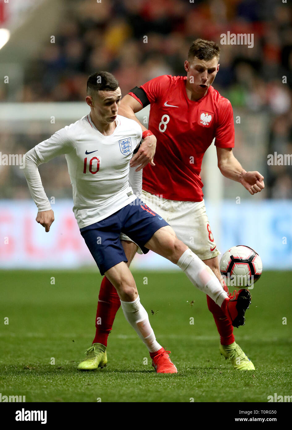 England's Phil Foden (left) and Poland's Jakub Piotrowski (right ...