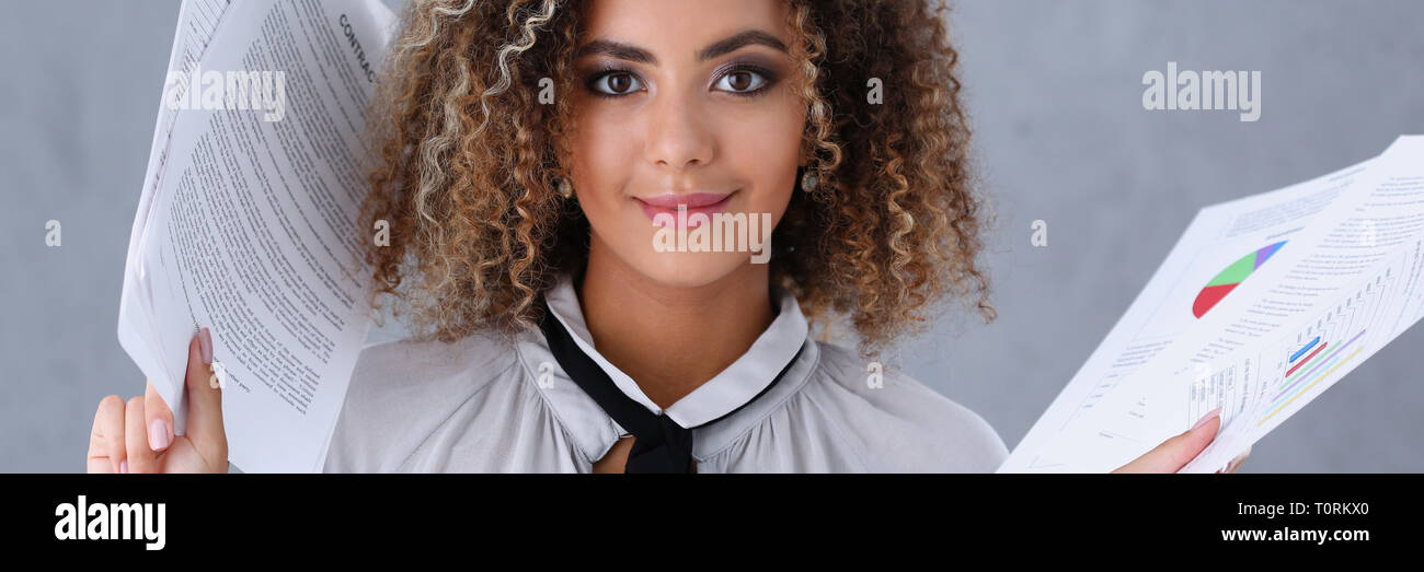 Beautiful black woman portrait. Holds paper documents Stock Photo - Alamy