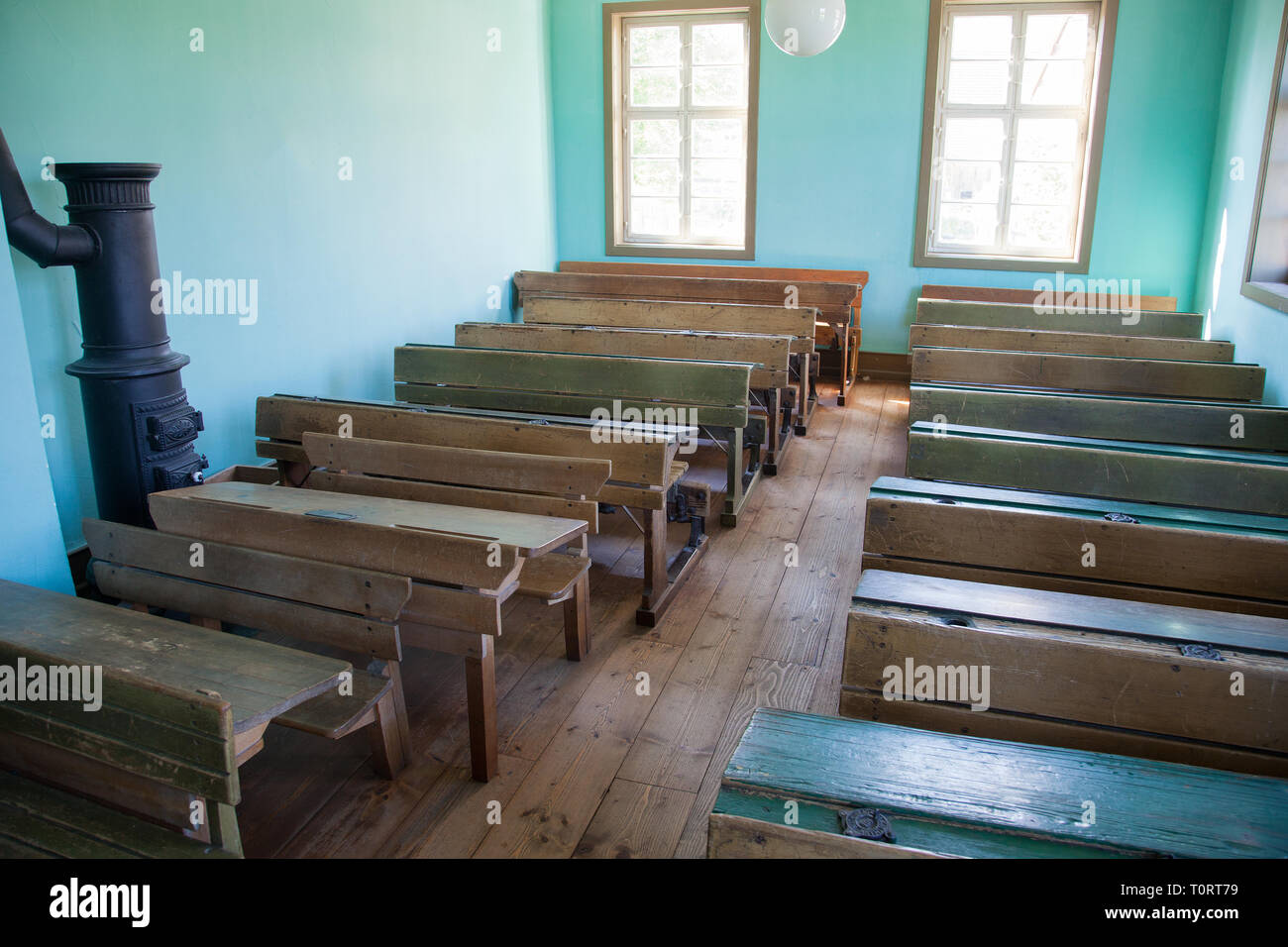 Antique classroom with empty wooden desks and benches Stock Photo - Alamy