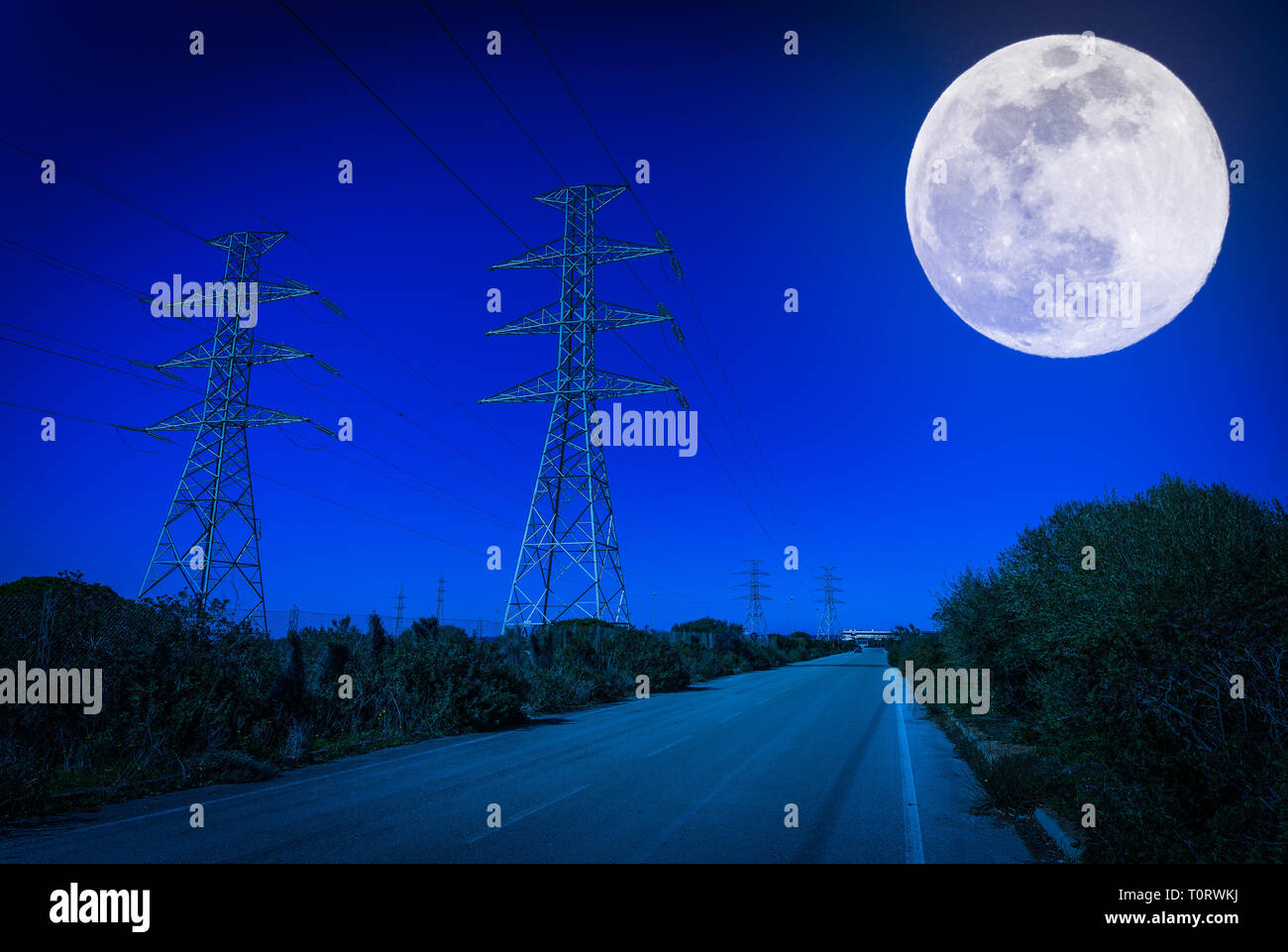 Landscape with electric pylons at night with supermoon Stock Photo - Alamy