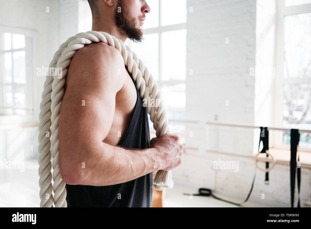 Close up portrait strong fit man with ropes in cross gym. Muscular ...