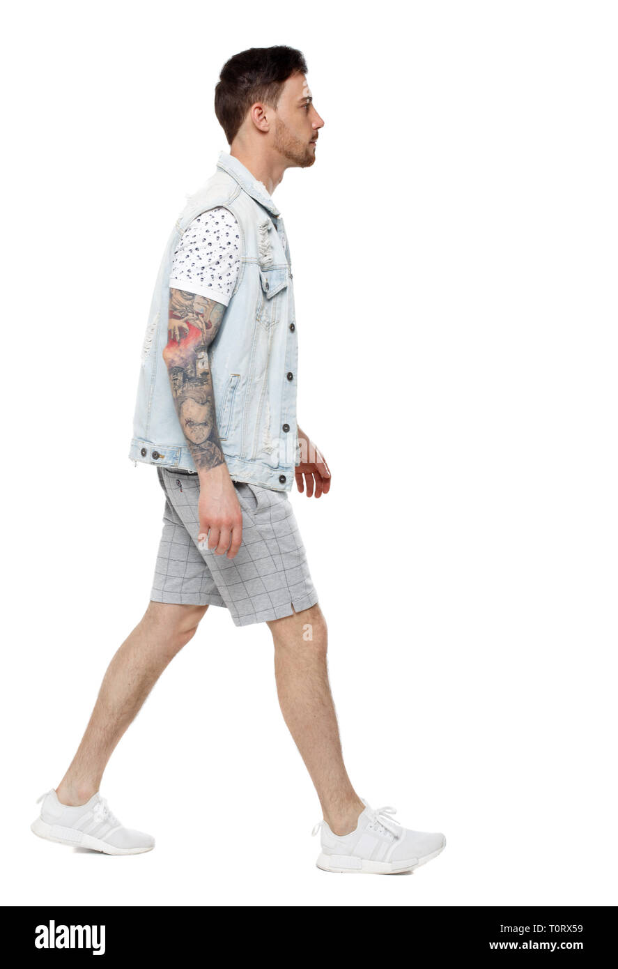 Back view of going handsome man in a shorts. walking young guy . Rear ...
