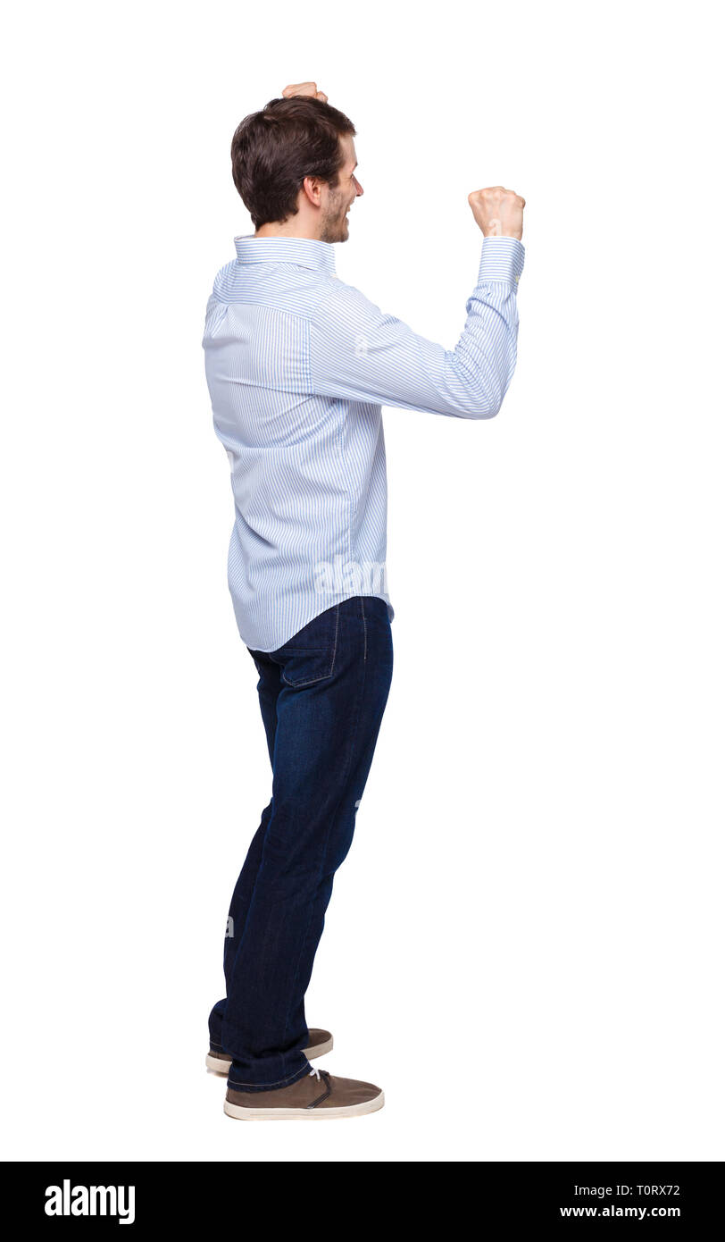 Back view of a man celebrating victory. The fan joyfully raised his ...