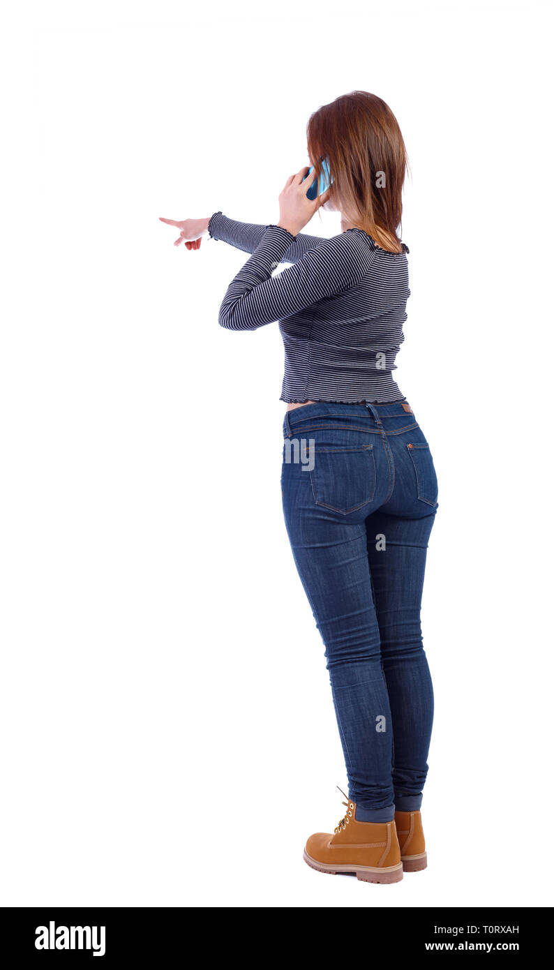 Back view of pointing young women talking on cell phone. Young girl ...