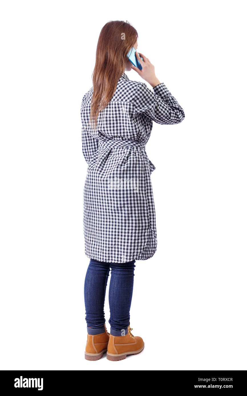 back view of a woman talking on the phone. backside view of person ...