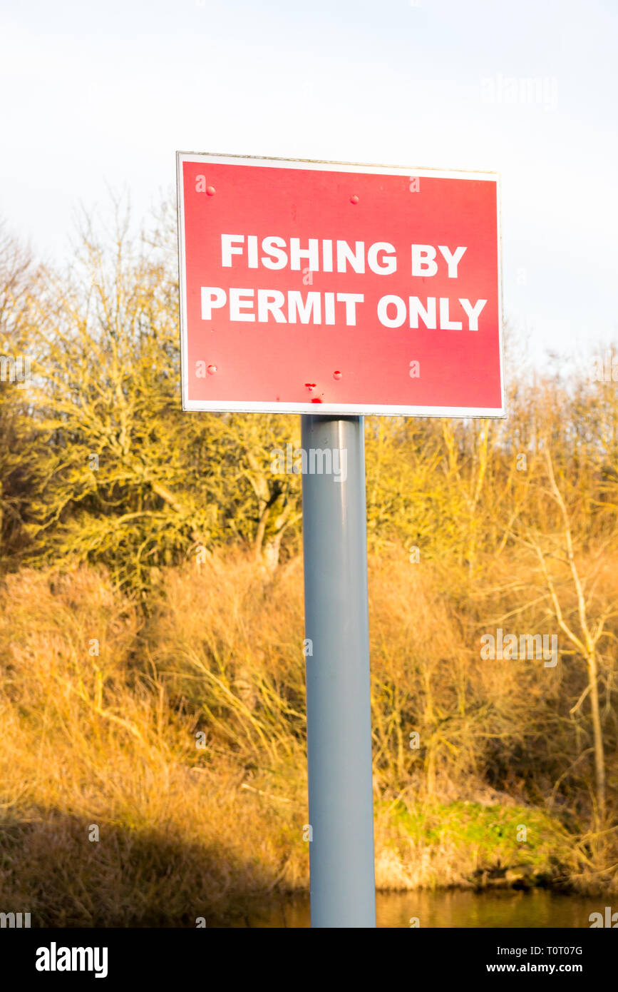 A 'Fishing by Permit Only' Sign on a Riverbank Stock Photo - Alamy