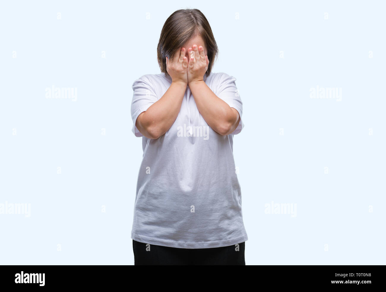 Young adult woman with down syndrome over isolated background with sad ...